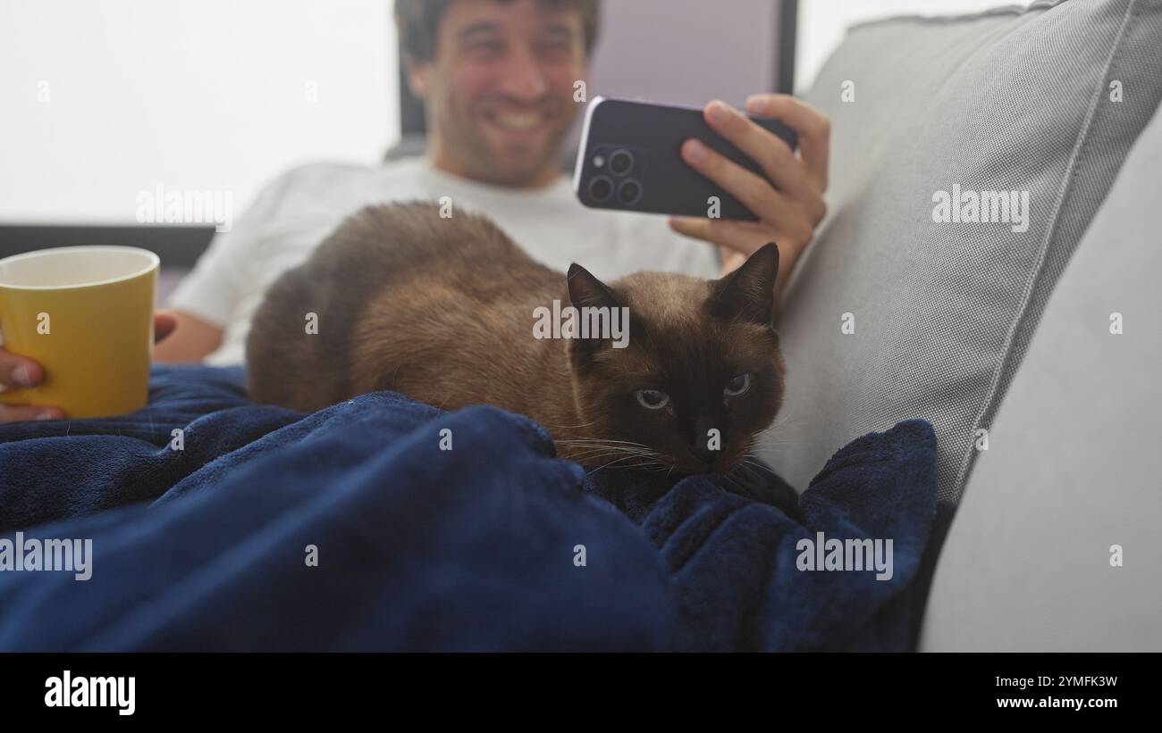 Smiling man takes selfie siamese hi-res stock photography and images ...