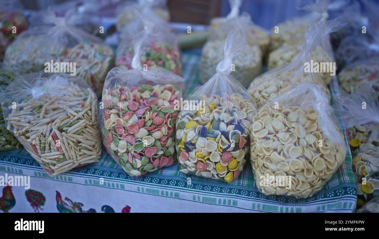 Colorful pasta bags displayed on an outdoor market table in bari ...