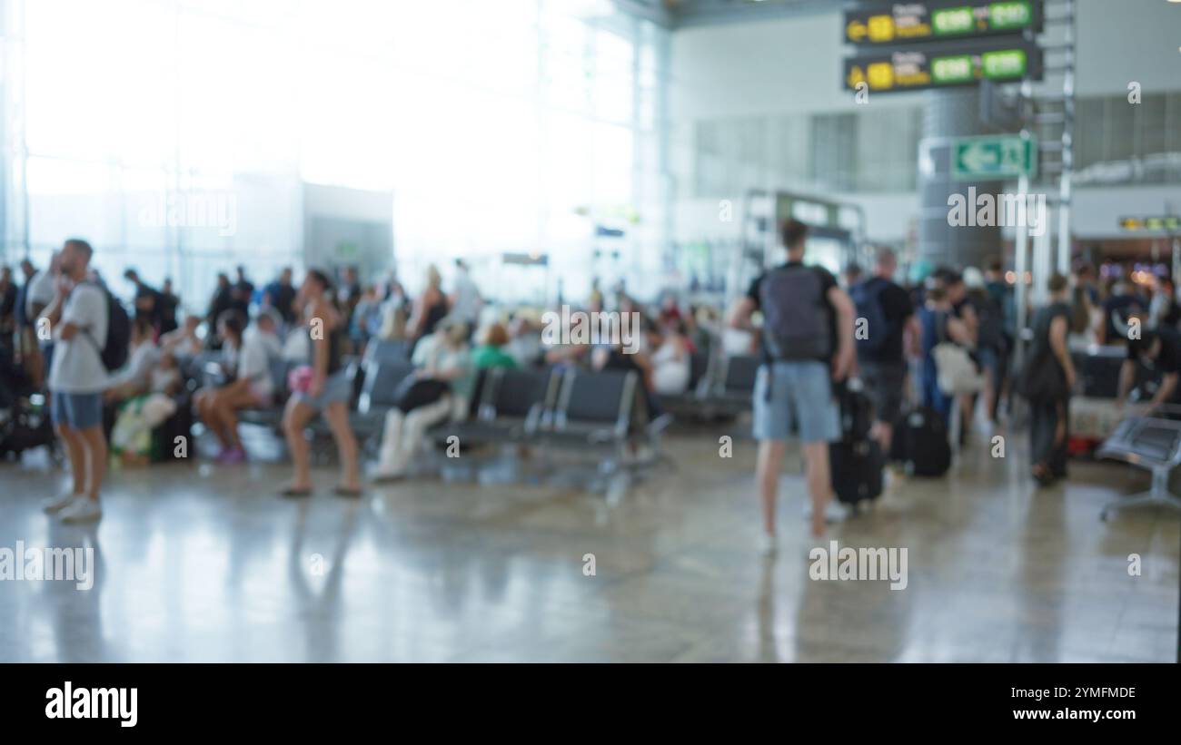 Crowded airport terminal with blurred travelers waiting for flights ...