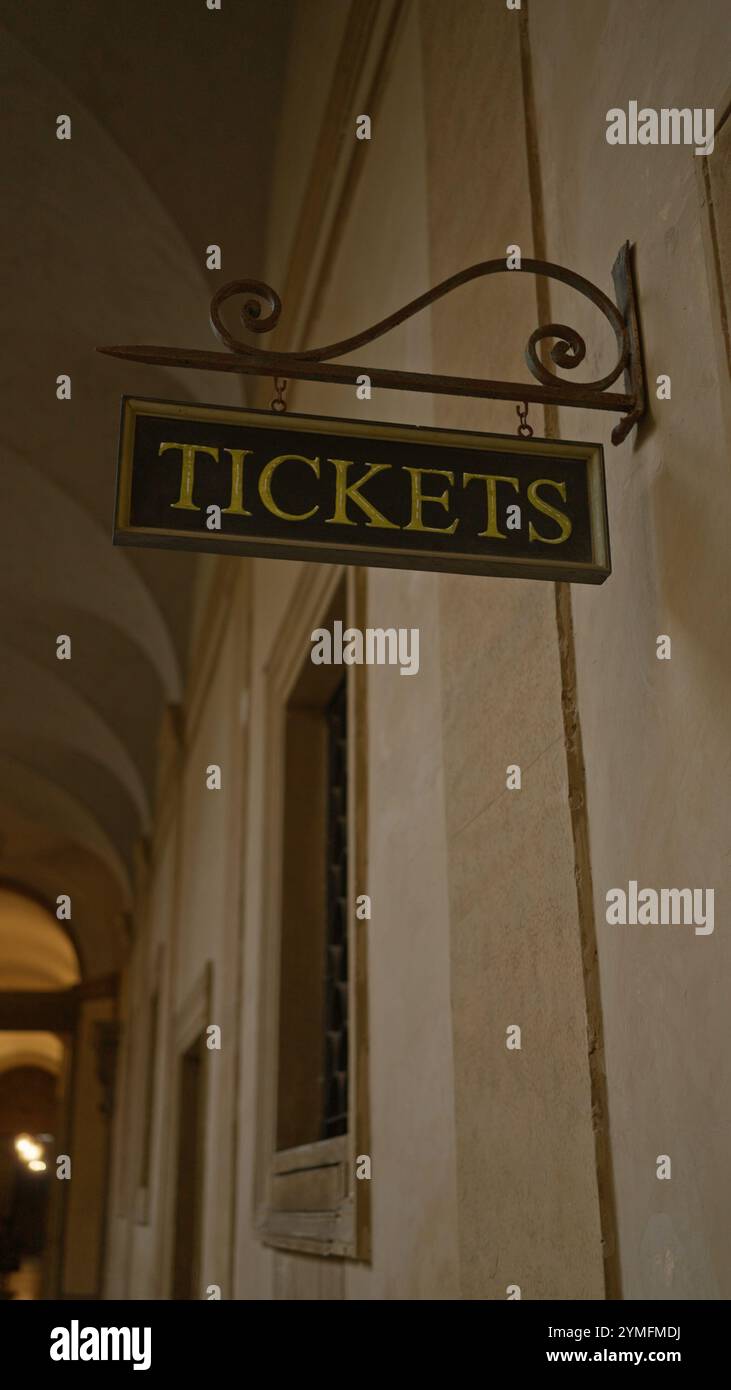 Vintage ticket sign hanging in a dim museum corridor with arched walls ...