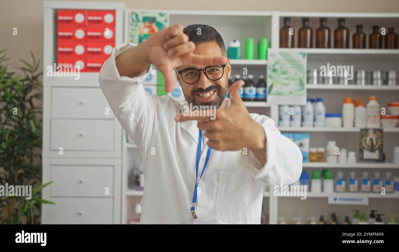 A cheerful hispanic pharmacist frames his face with his hands in a well ...