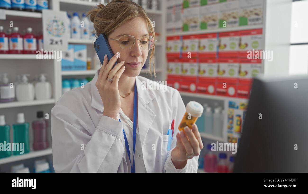 A young woman pharmacist answering a phone call while checking ...