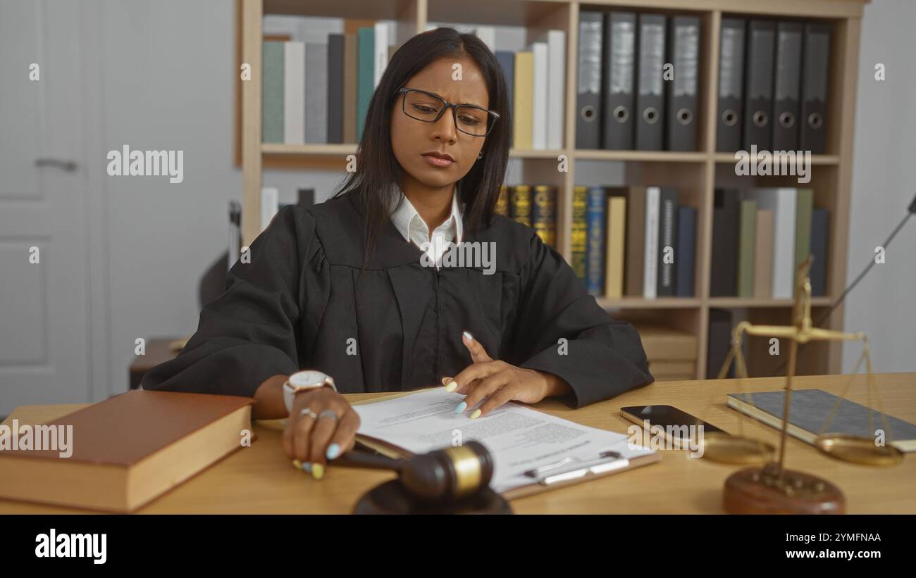 Woman judge in black robe analyzing documents in an office, with a ...