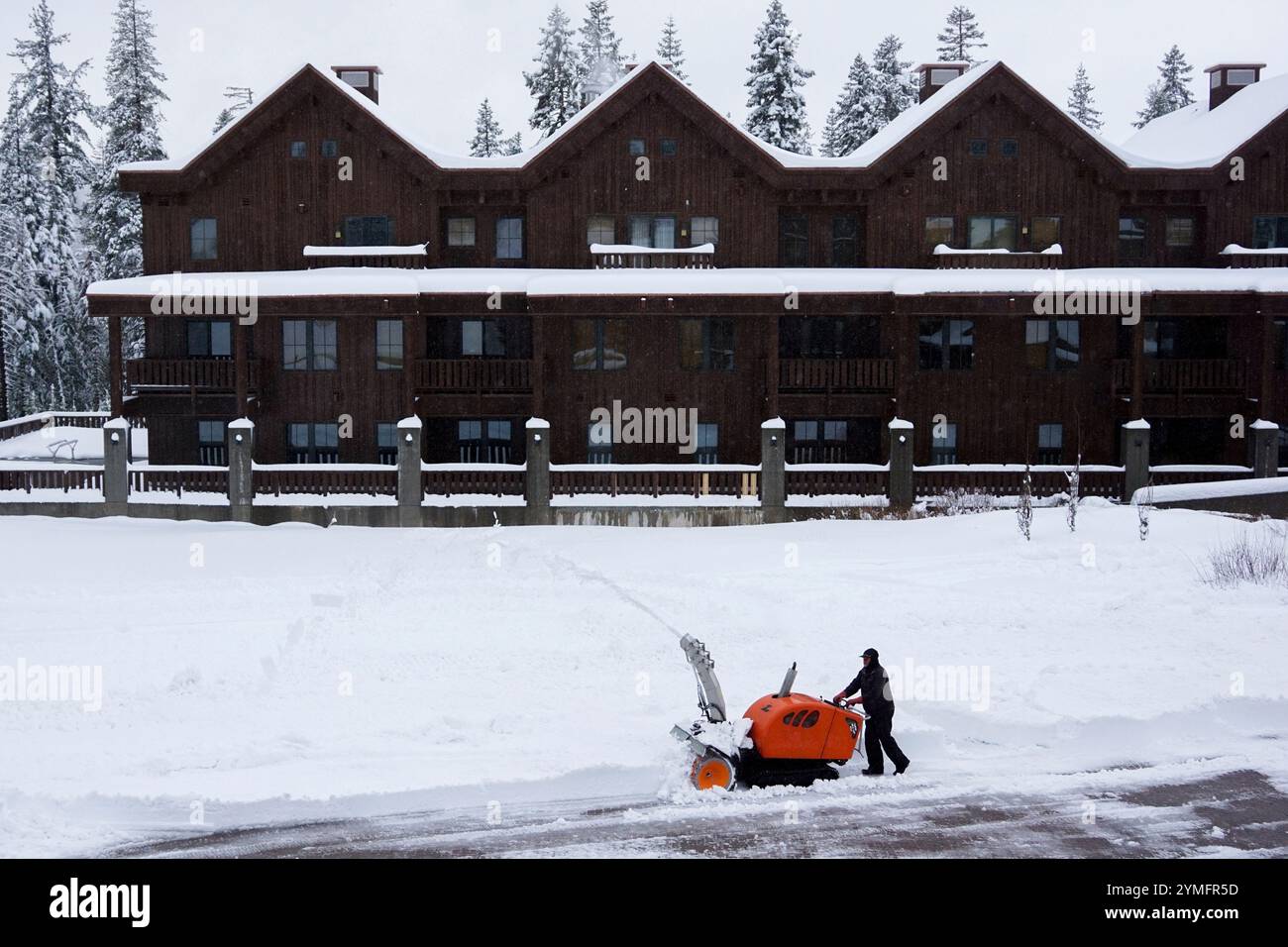 A worker clears a road with a snow blower during a storm Thursday, Nov ...