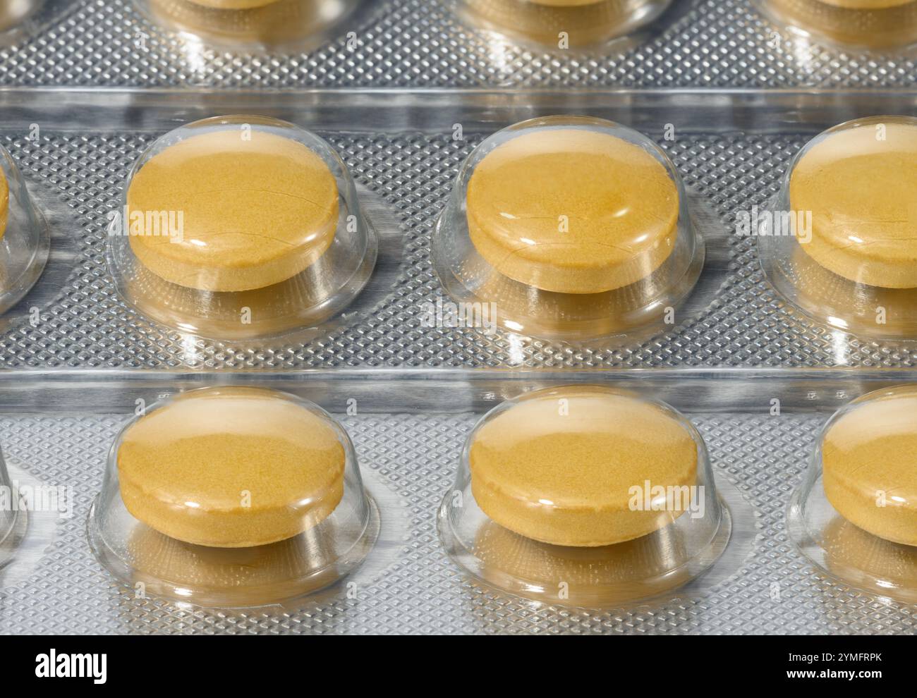 Blister pack with round yellow pills, close up Stock Photo - Alamy