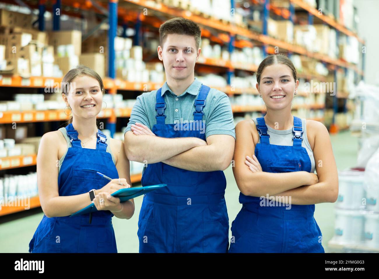 Portrait of three construction supermarket workers in overalls Stock ...