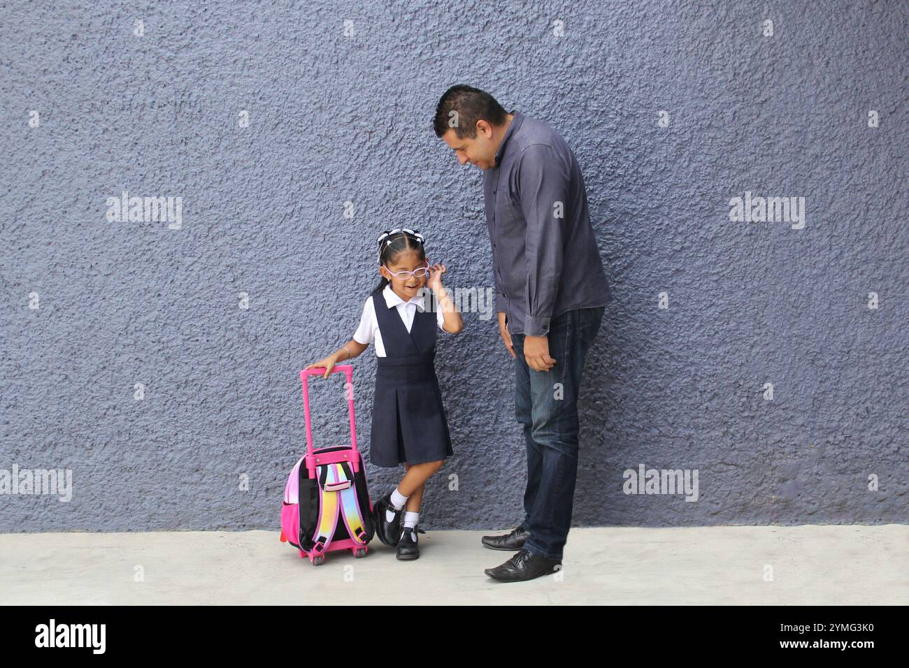 Divorced single dad walks to school with his 4 year old brunette daughter carrying her backpack ...