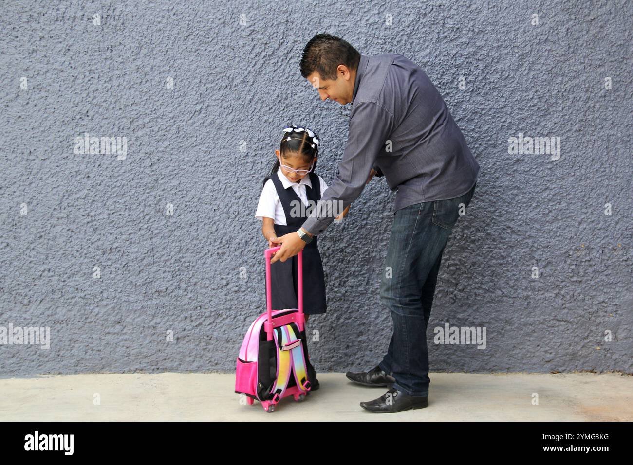 Divorced single dad walks to school with his 4 year old brunette daughter carrying her backpack ...