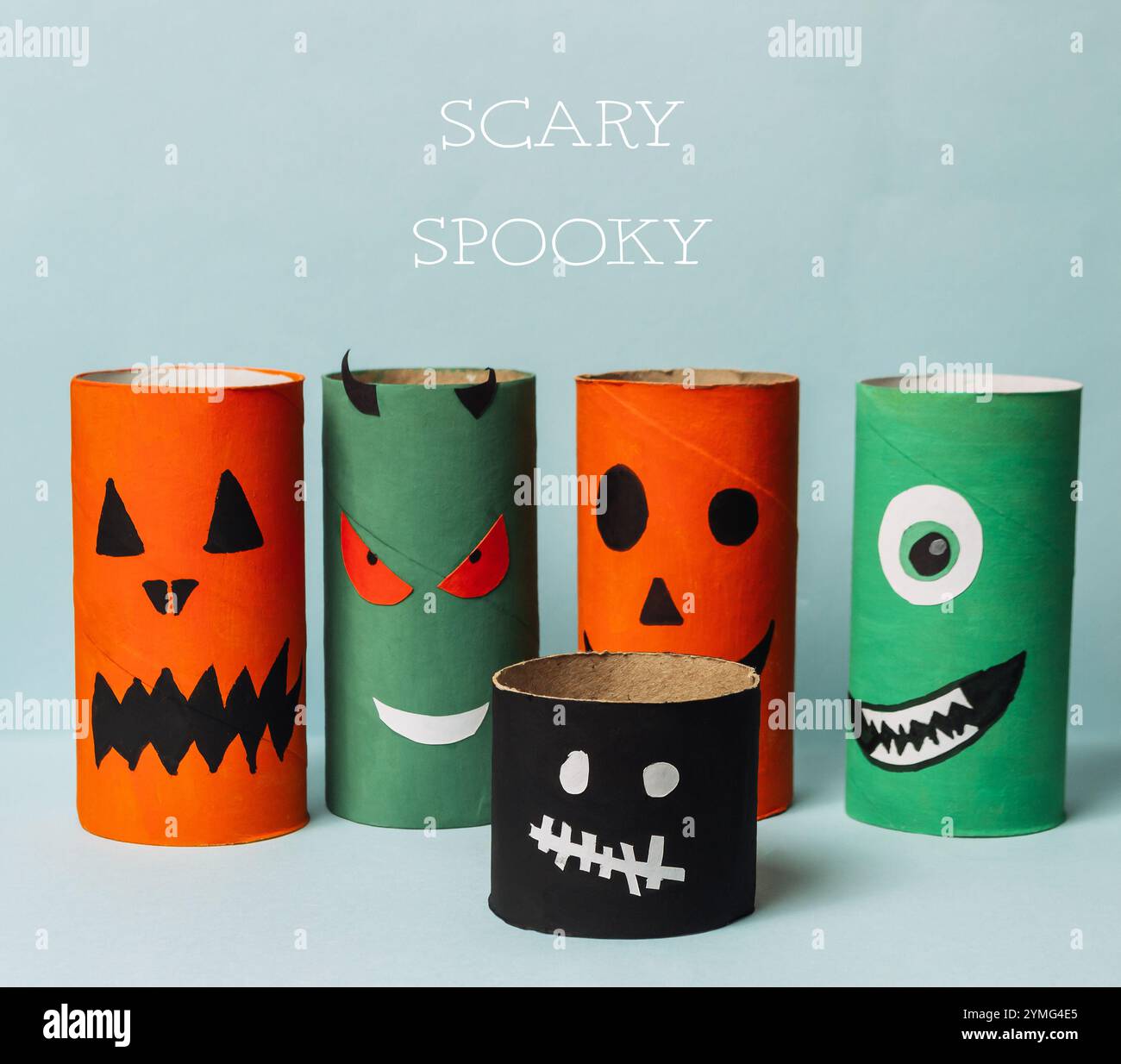 Collection of paper tubes with scary faces on them, including a green ...