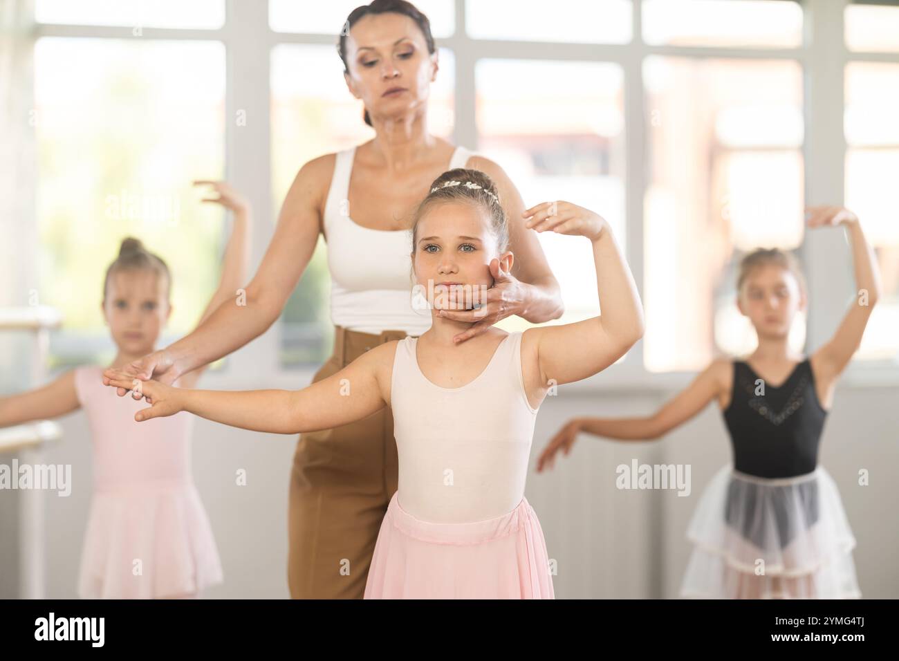 Group of girls stand in third position Stock Photo - Alamy