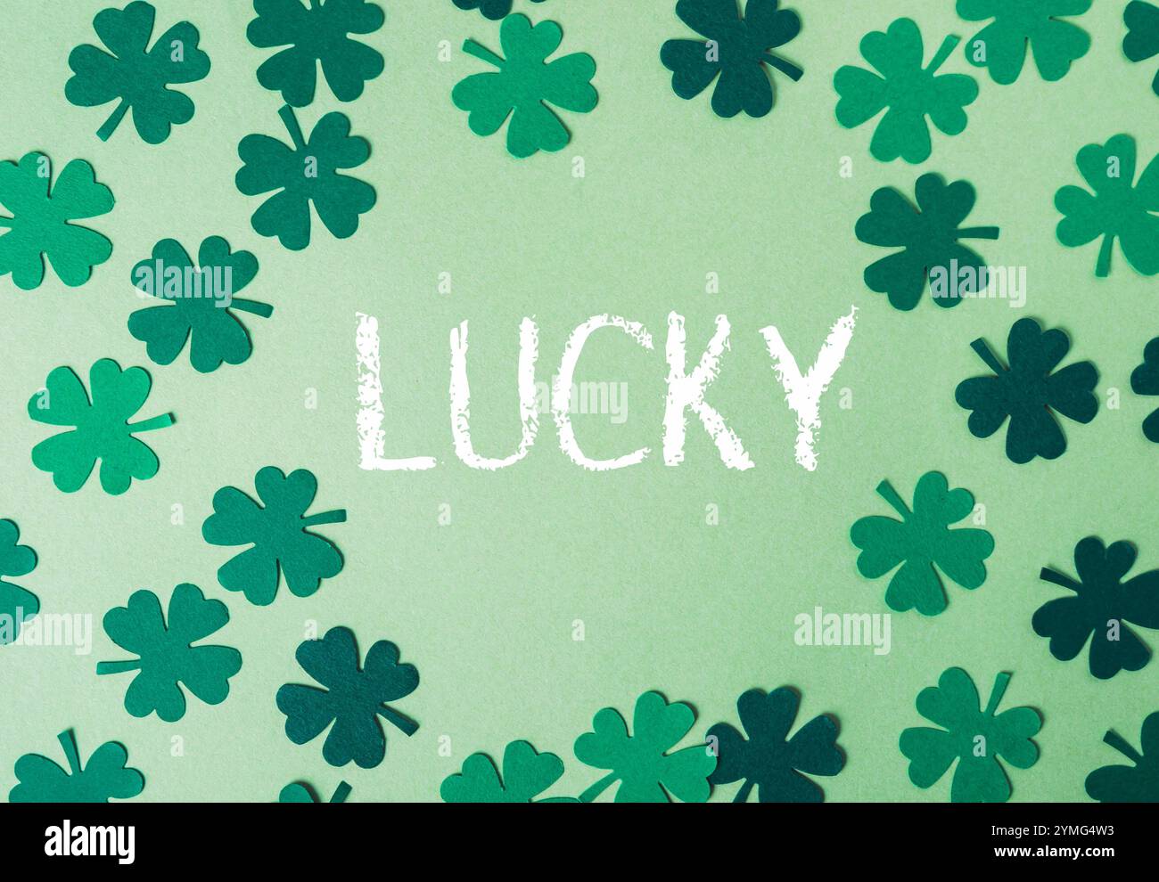 A green background with a bunch of shamrocks and the word lucky written ...