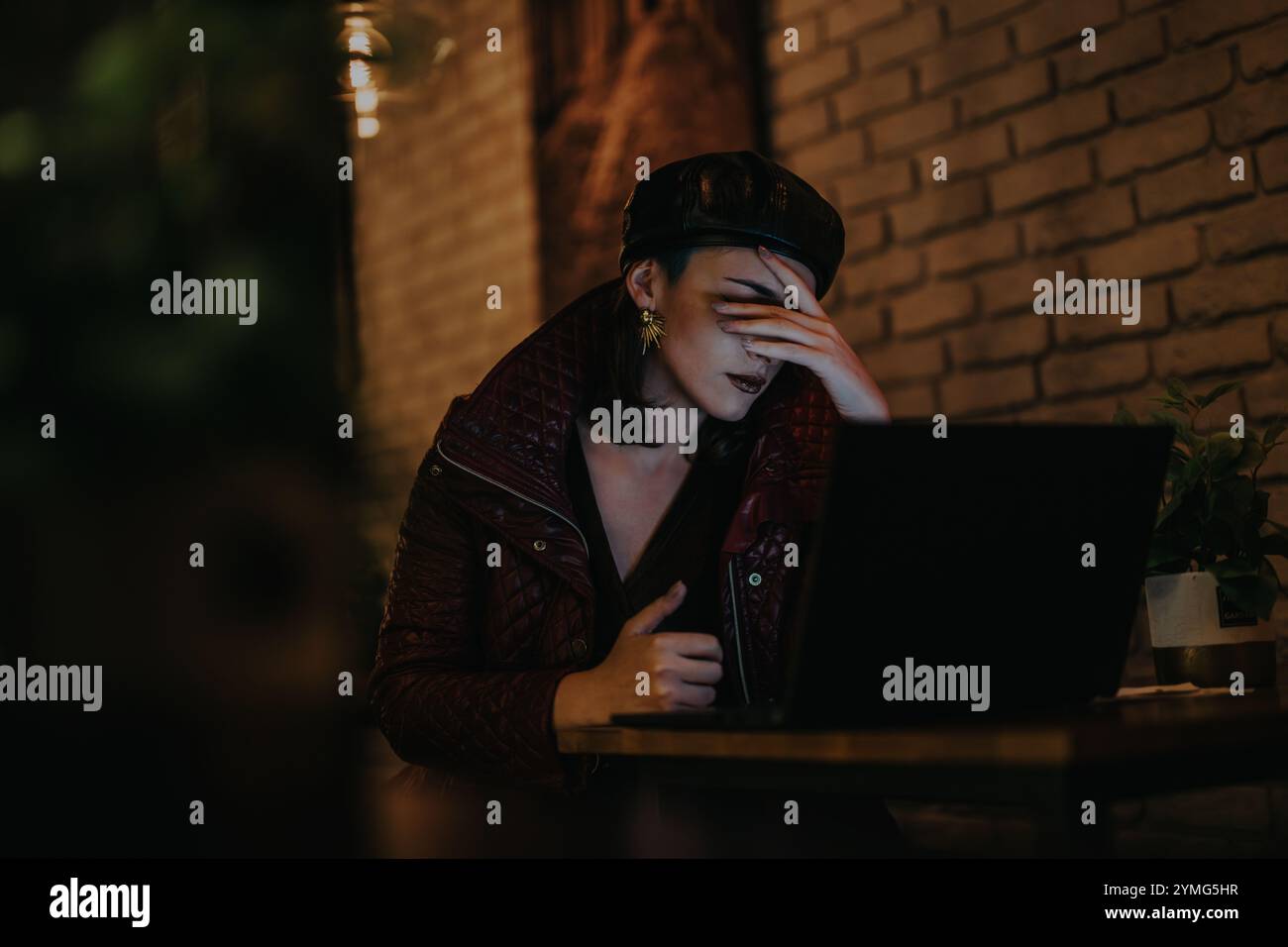 Business person working late at night in a cozy coffee shop Stock Photo ...