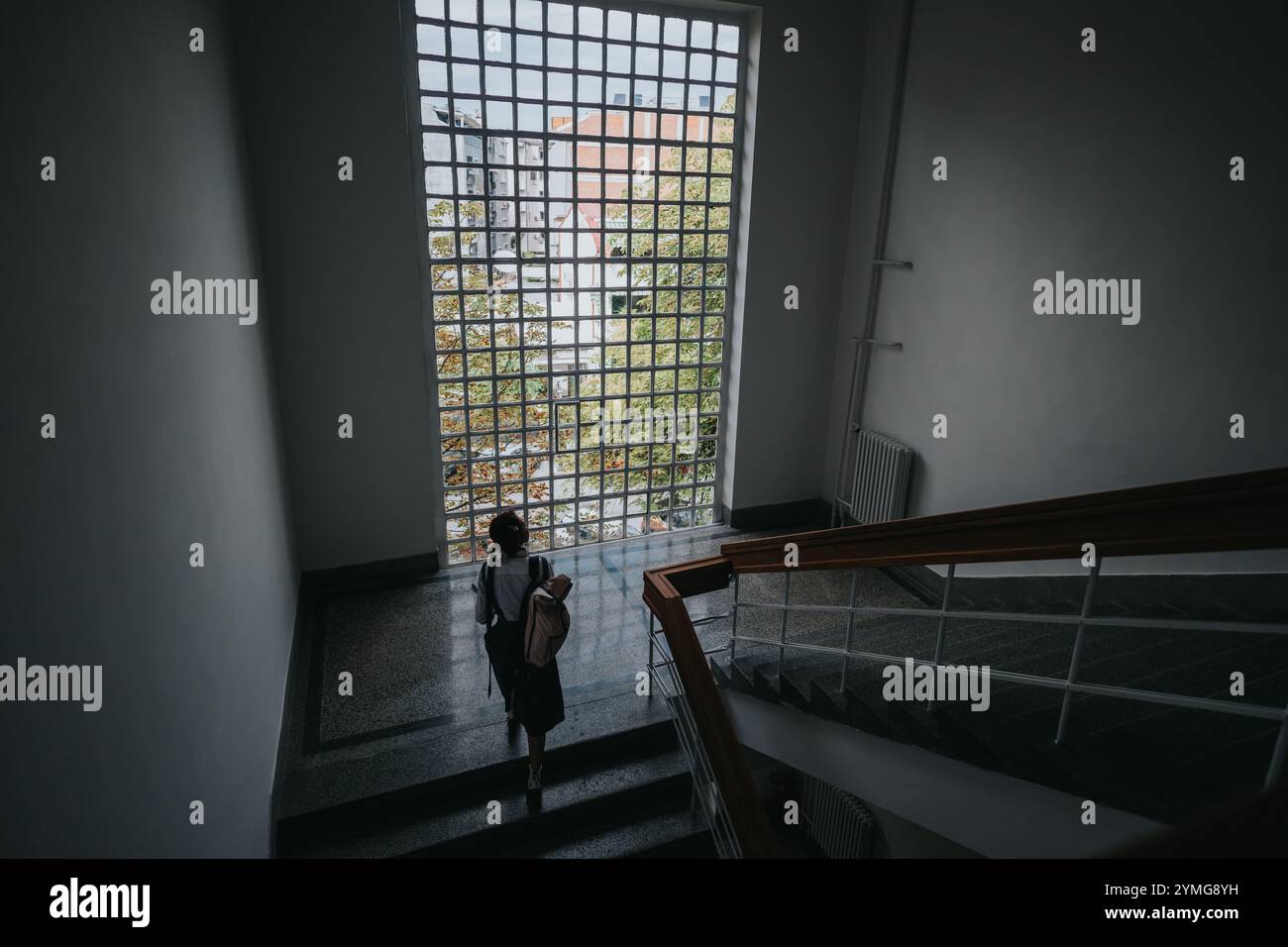 Students walking in a modern building with large windows Stock Photo ...