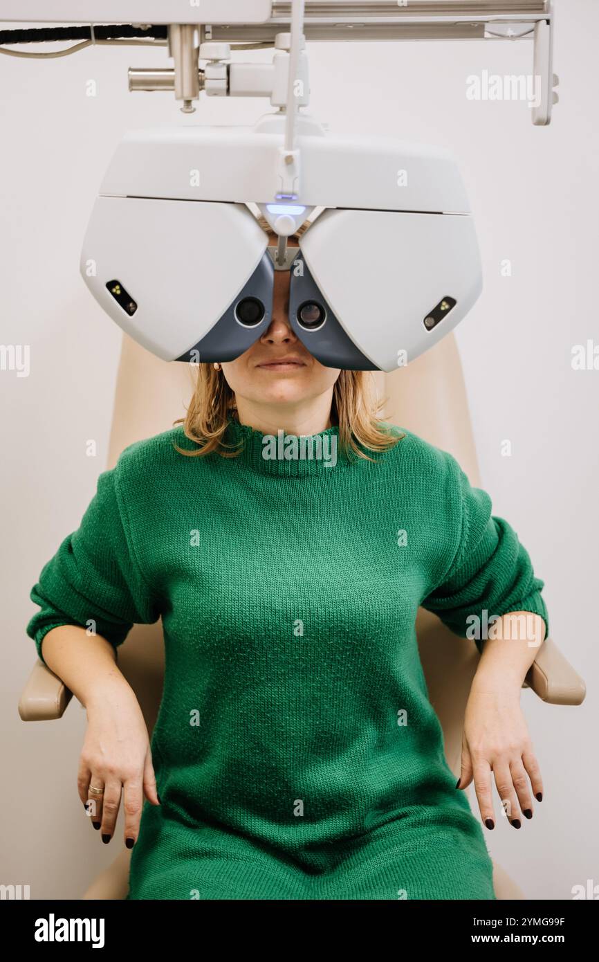 Patient undergoing advanced vision test with modern optometry equipment ...