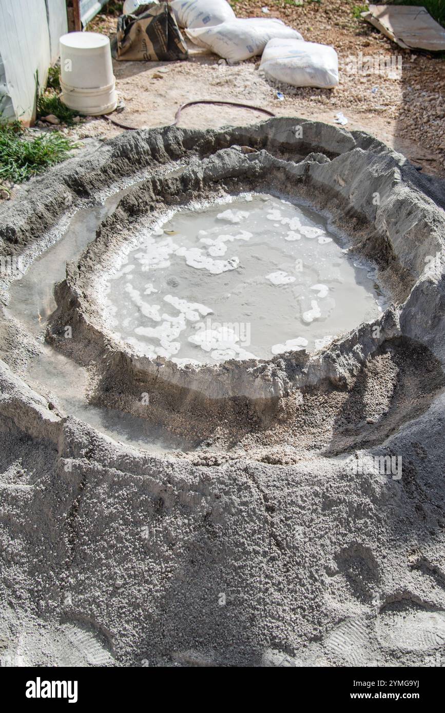 Cement powder pile with wet crater in the middle ready to be mixed ...