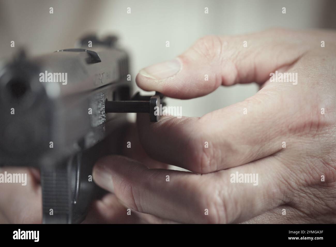 Man take care of semi automatic pistol handgun at home Stock Photo - Alamy