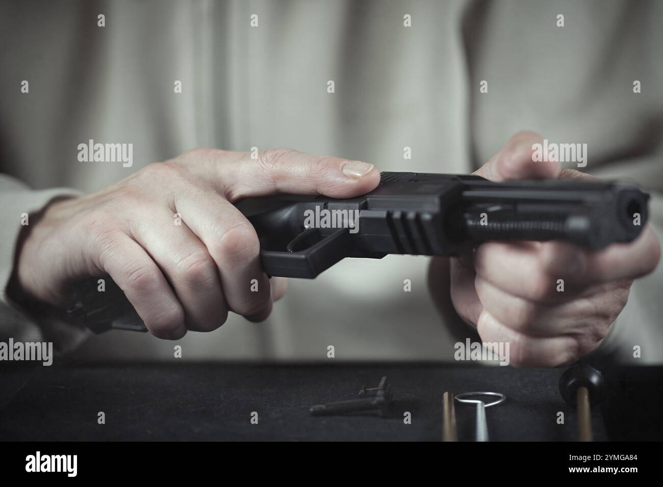 Man take care of semi automatic pistol handgun at home Stock Photo - Alamy