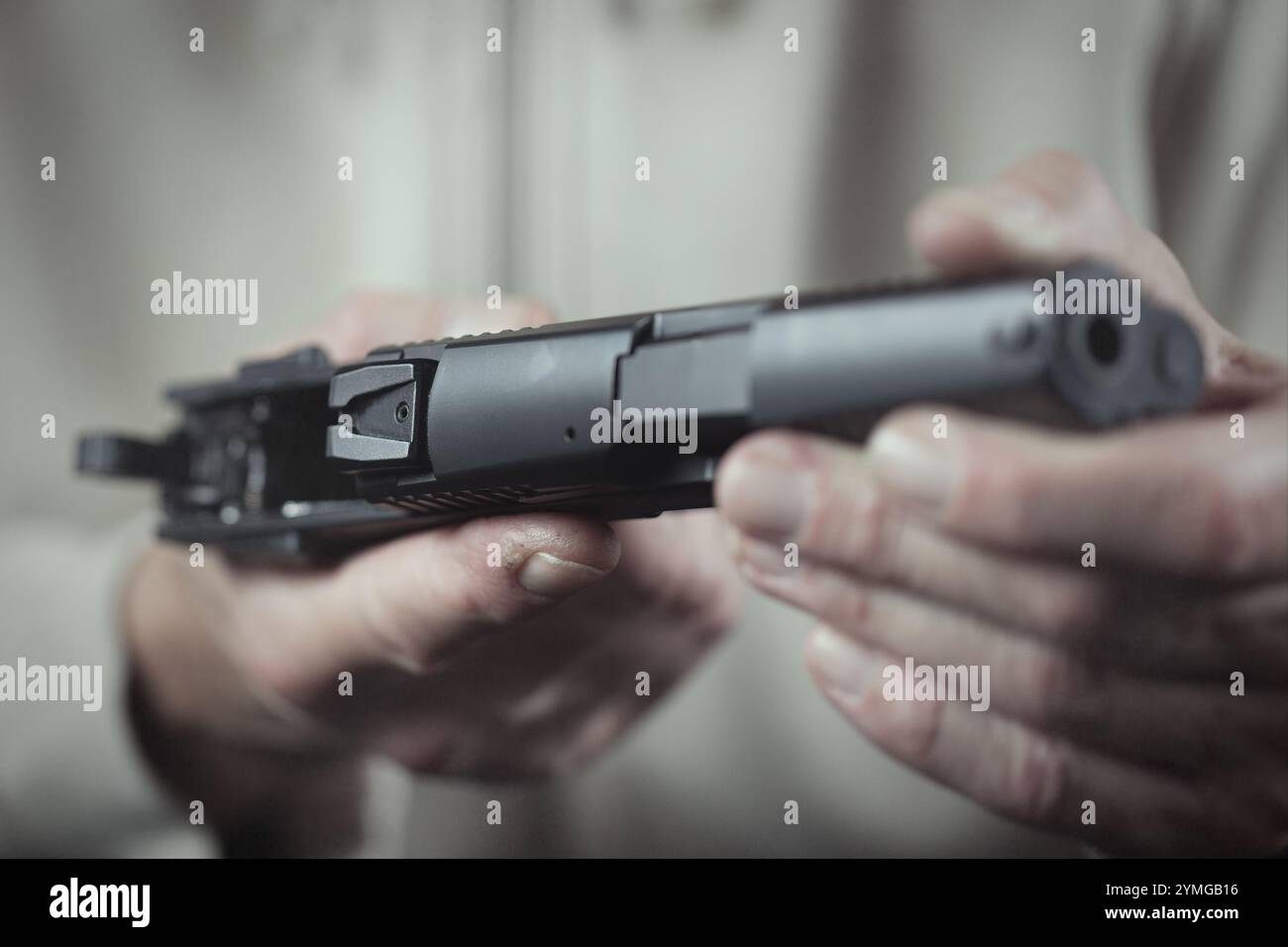 Man take care of semi automatic pistol handgun at home Stock Photo - Alamy