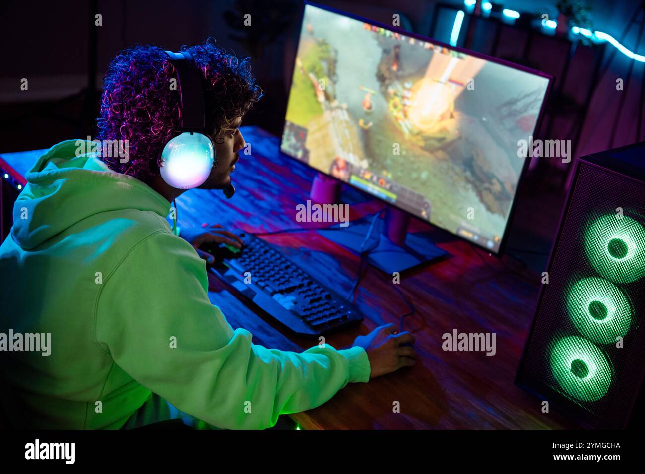 Photo of gamer nice young male big display play computer strategy game ...