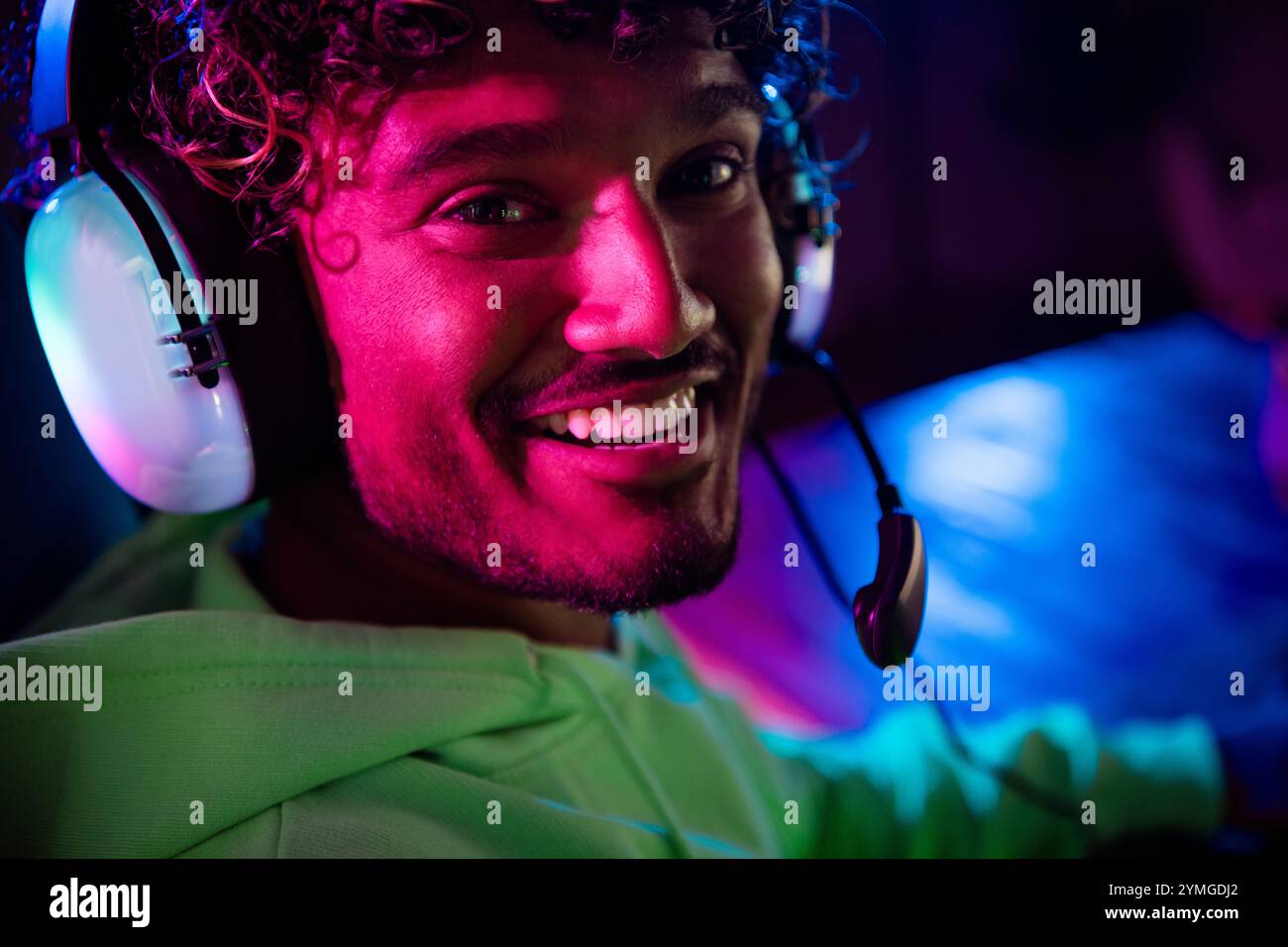 Photo of cute young guy cheerful toothy smile play gamer computer ...