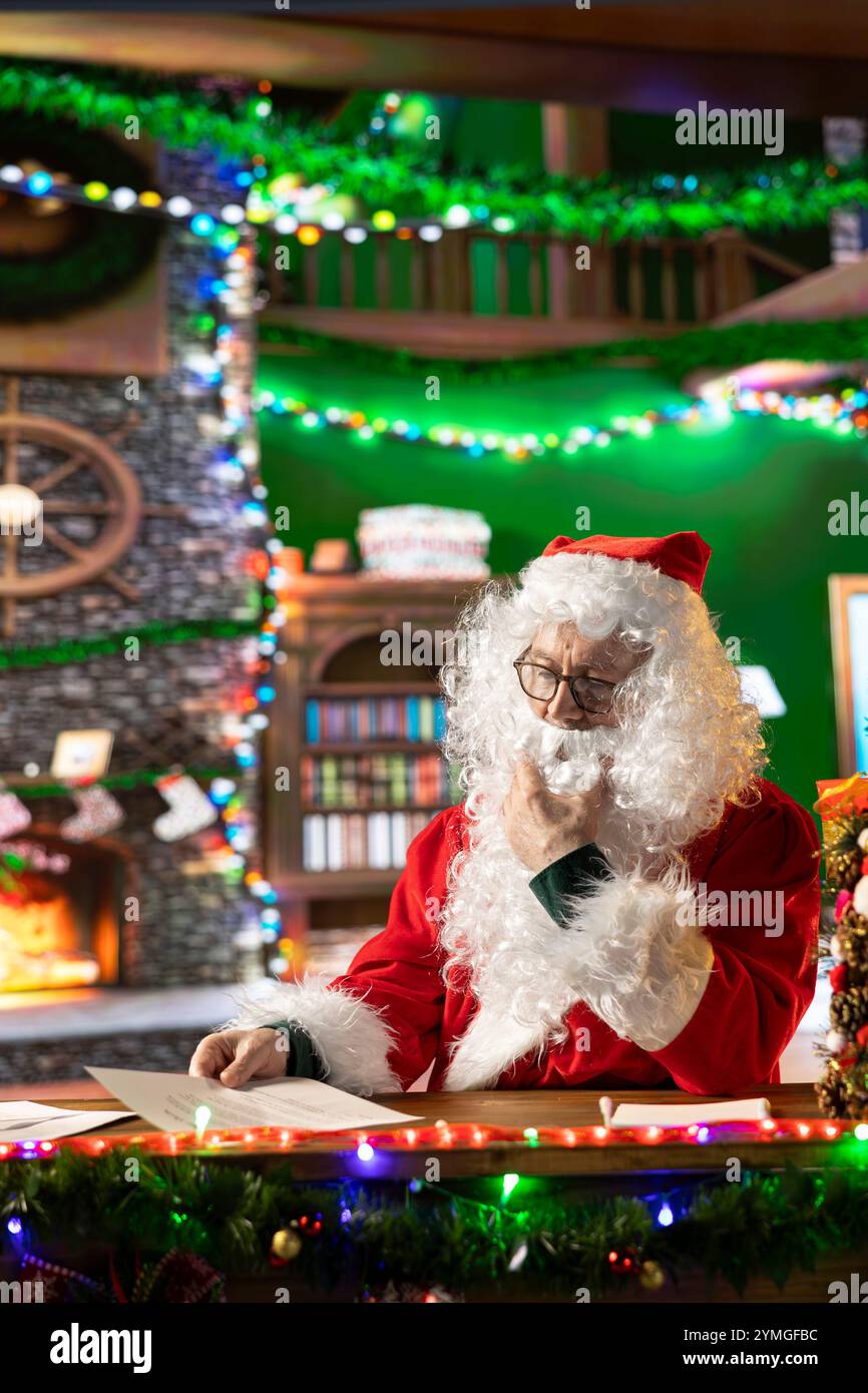 Santa Claus reading letters from children in his rustic cabin to share ...