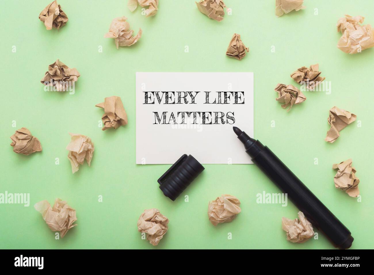 Every life matters is written on a piece of paper. A black marker is ...