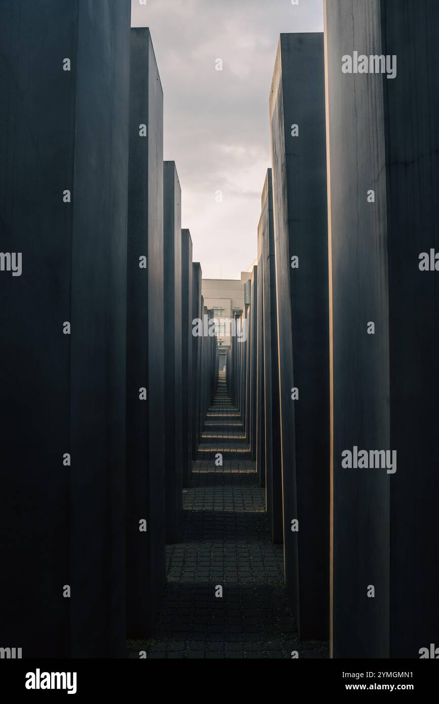 A straight line of sturdy concrete columns leading up to a large ...