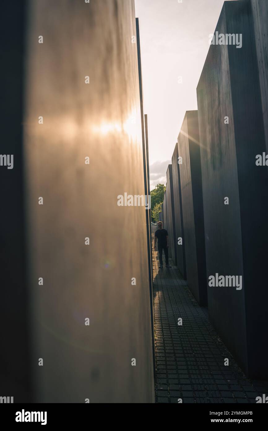 A straight line of sturdy concrete columns leading up to a large ...