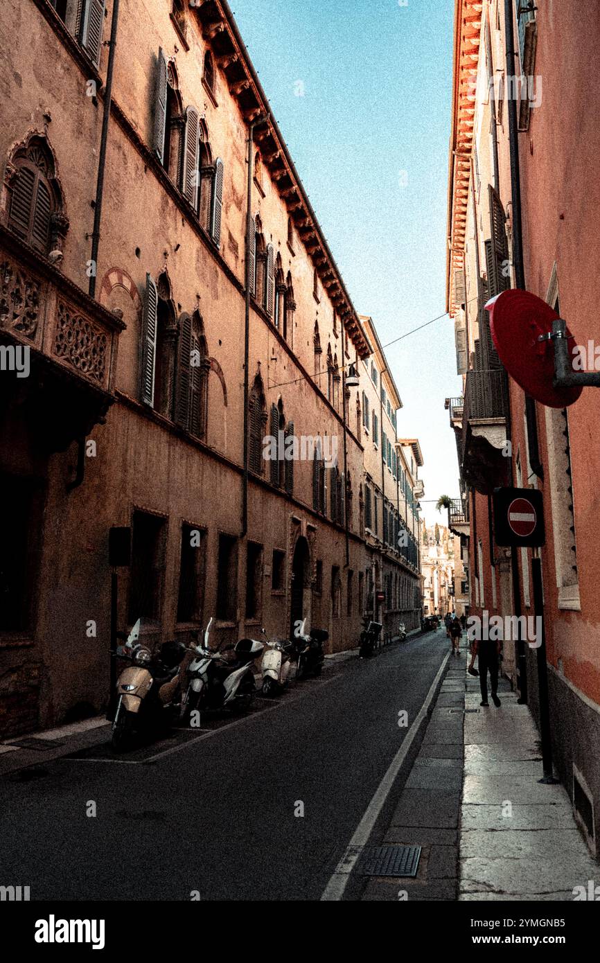 There exists a narrow street that features a prominent red no entry ...