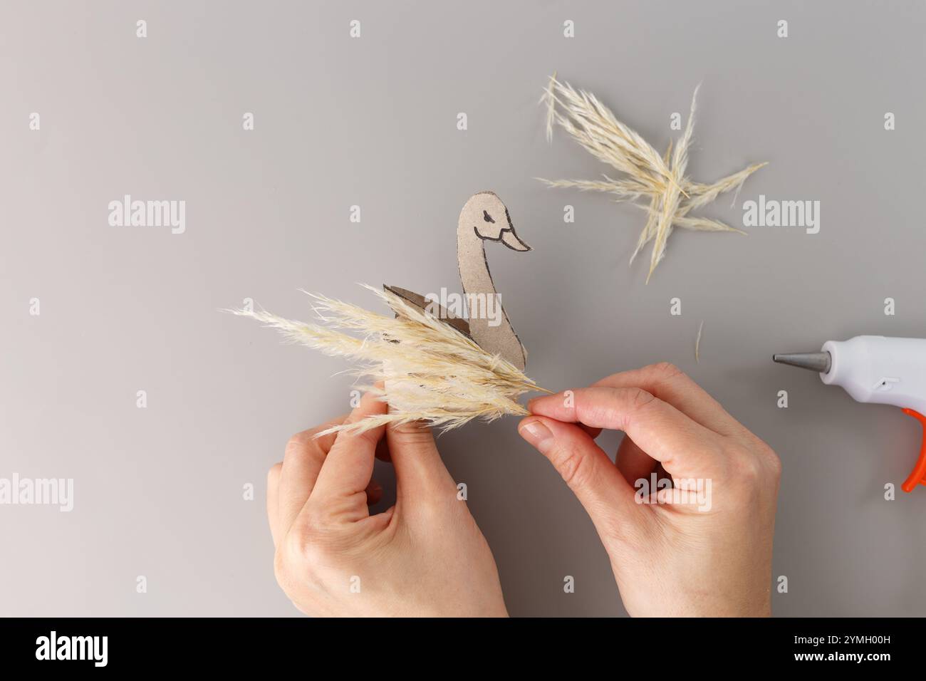 step in creative process, swan craft made of dry grass and empty toilet ...