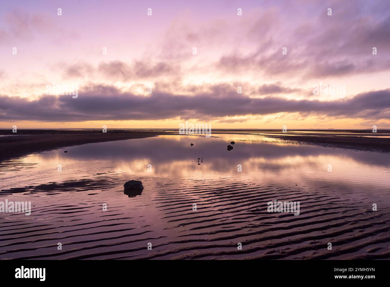 Spectacular pink sunrise reflected on sand ripples, Carmila Beach ...