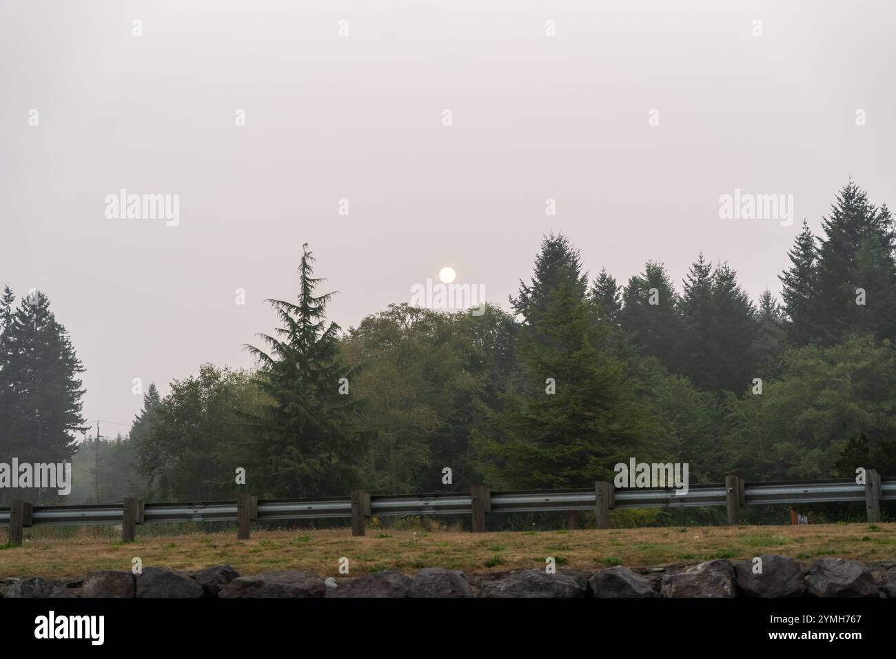 A hazy orange sun shining through heavy wildfire smoke in Washington ...