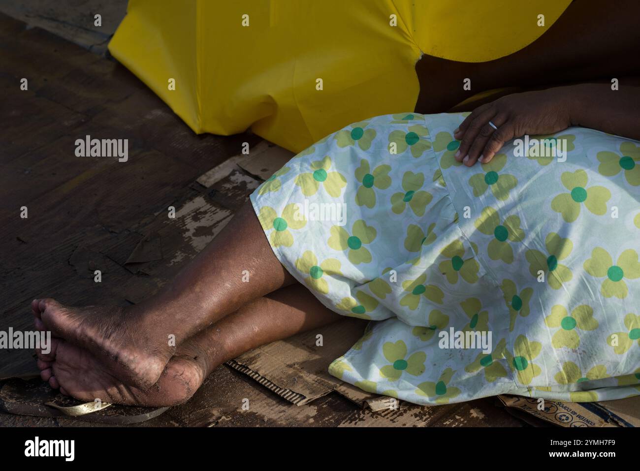 legs and feet of an unidentified person sleeping on a mattress and ...