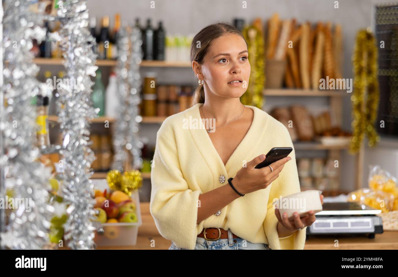 Woman scanning qr code on cheese Stock Photo - Alamy