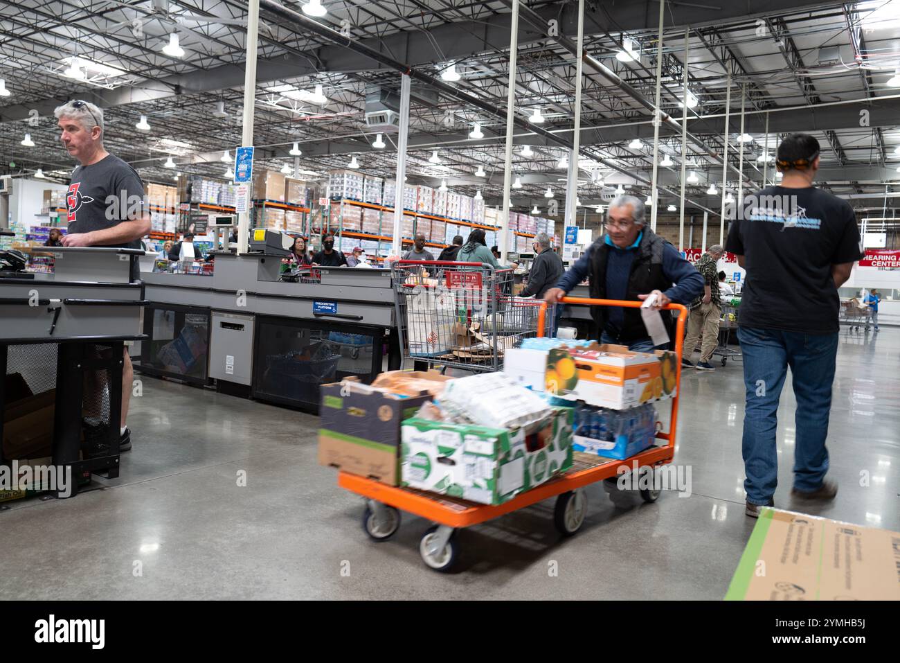 Images of a bustling Costco store featuring the exterior, entrance, and checkout areas ...