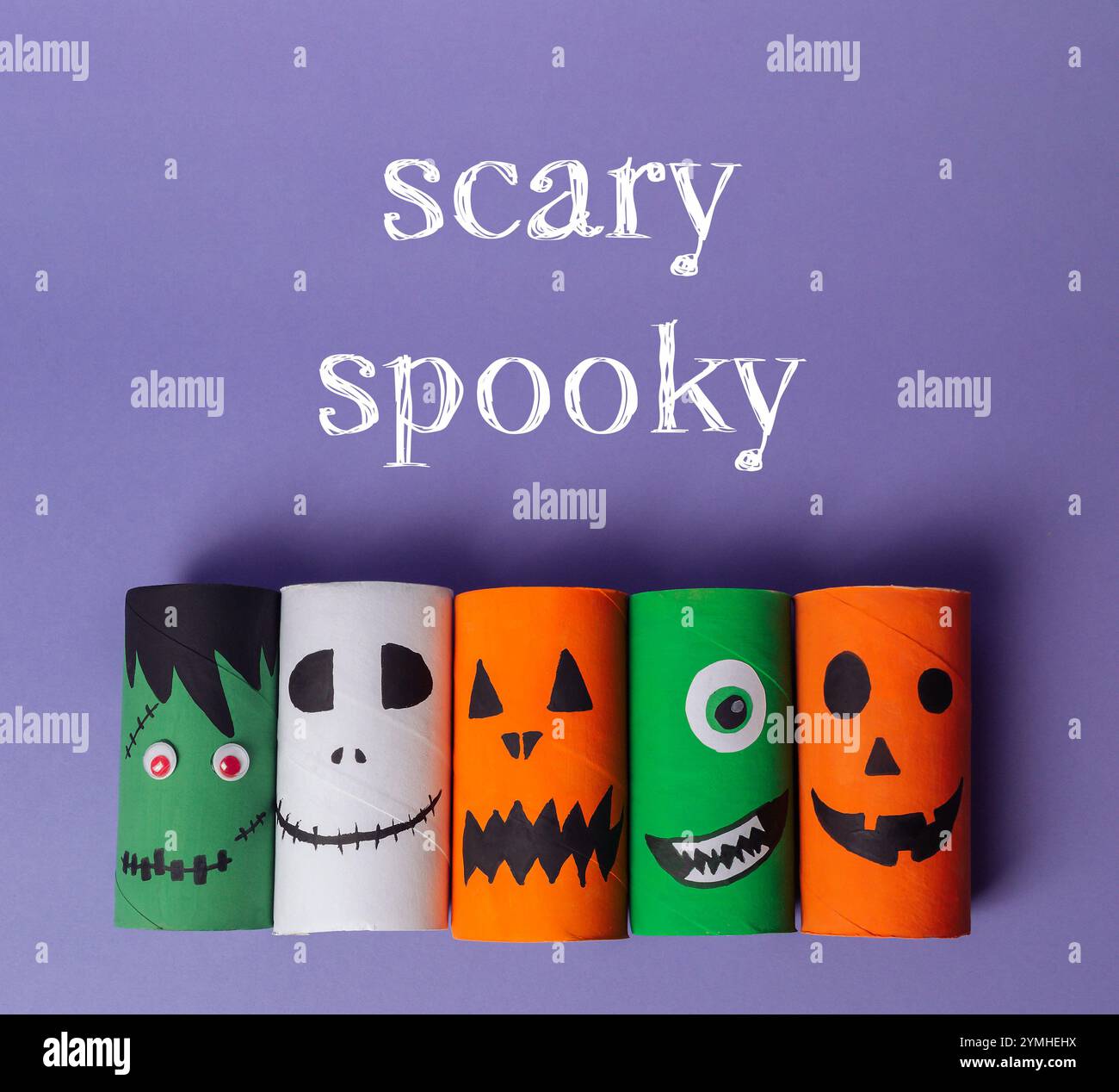 Group of paper tubes with scary faces on them. The tubes are arranged ...
