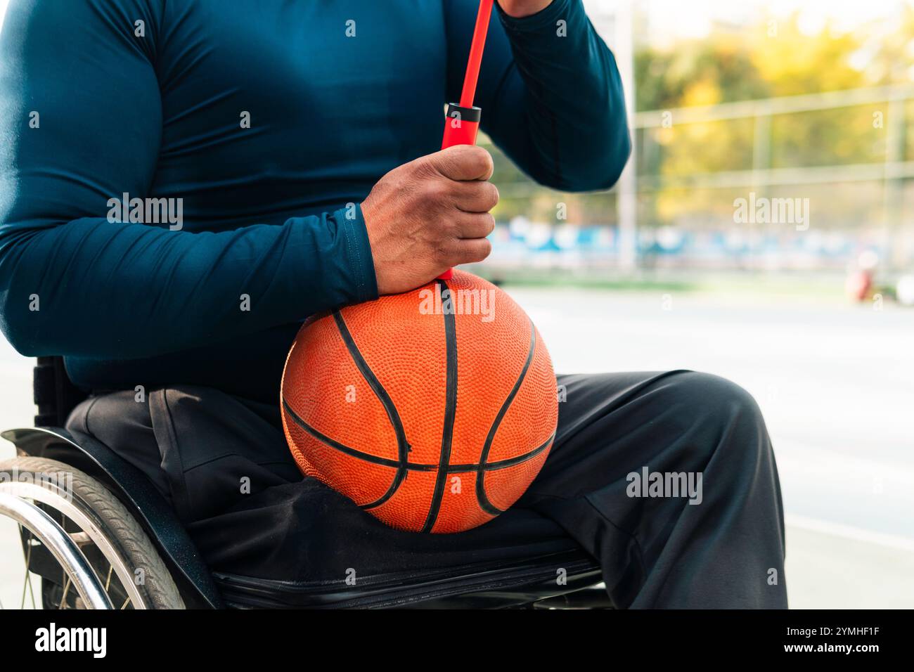 Adult male athlete about 50 years old, practicing basketball in a ...