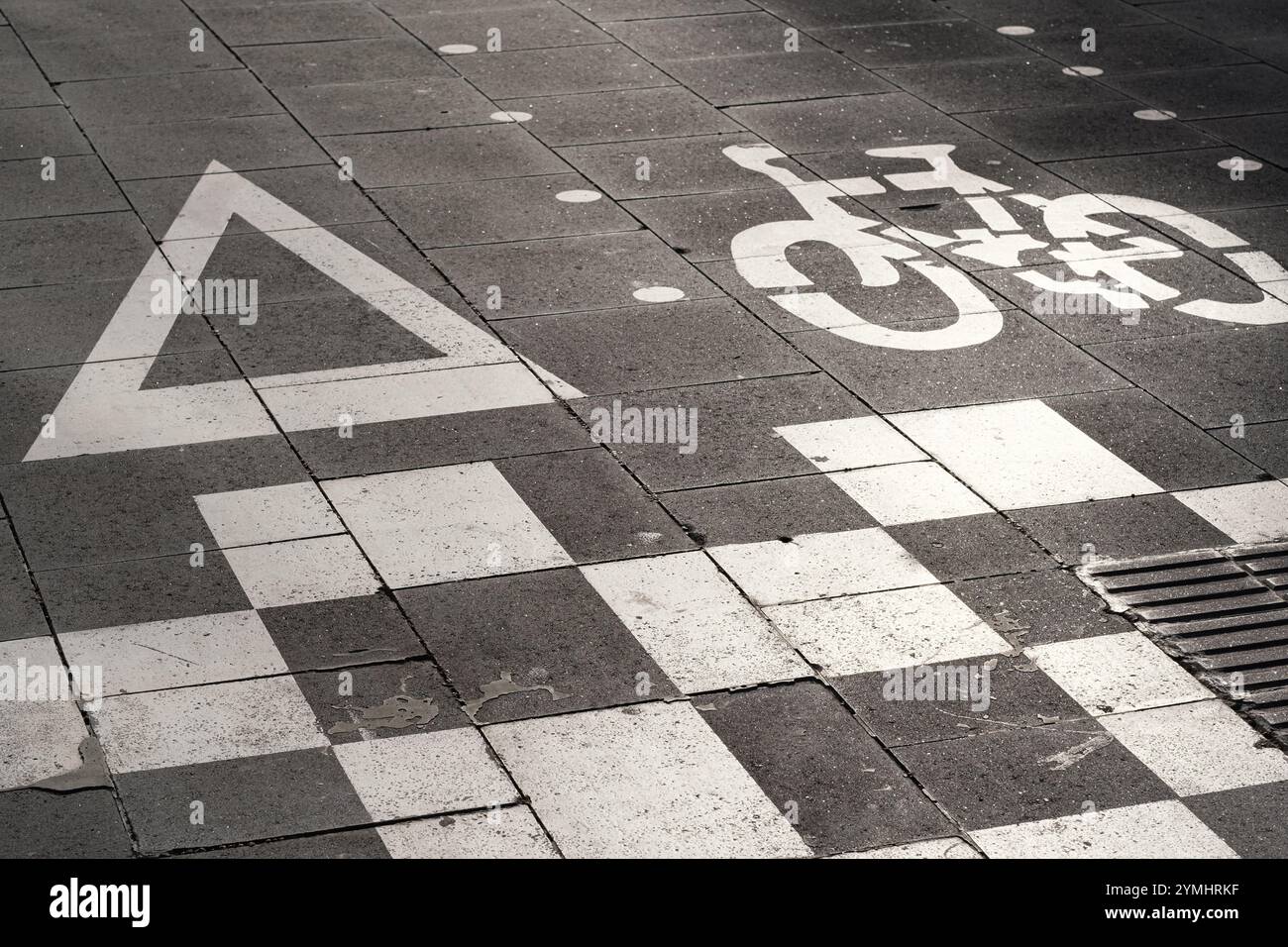 Horizontal signage of a cycle lane at a pedestrian crossing near a bus ...
