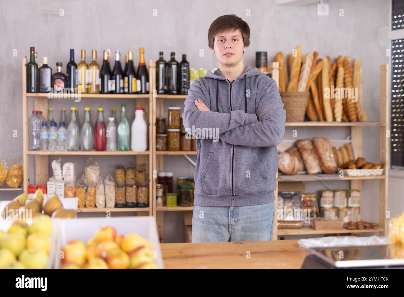 Customer near self-service counter hangs purchases on scale. Guy near ...