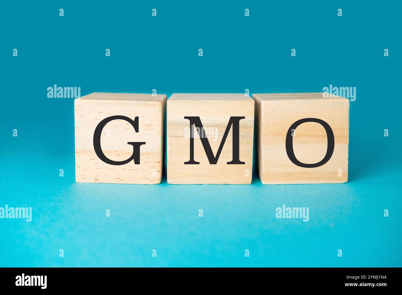 The image is a wooden block with the letters GMO on it. The blocks are ...