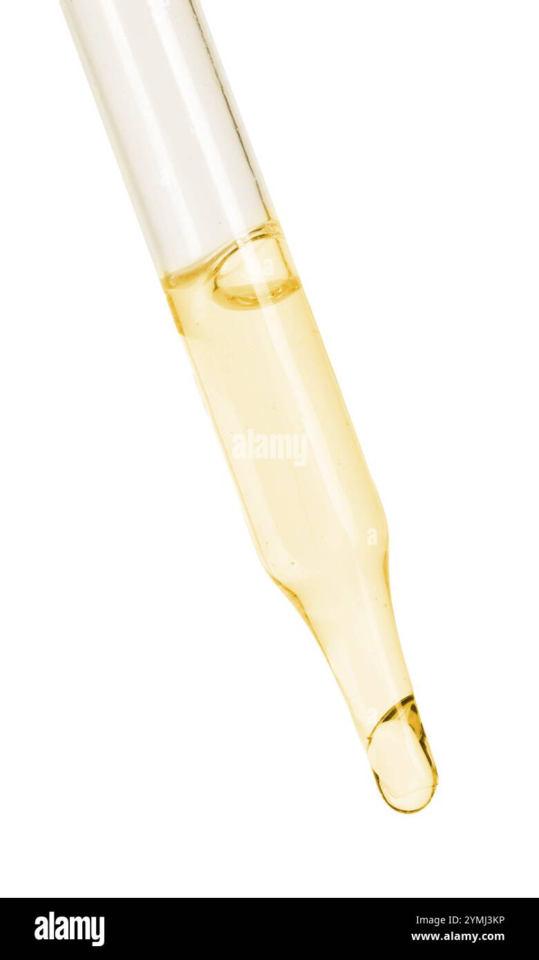 Dripping essential oil from pipette on white background Stock Photo - Alamy