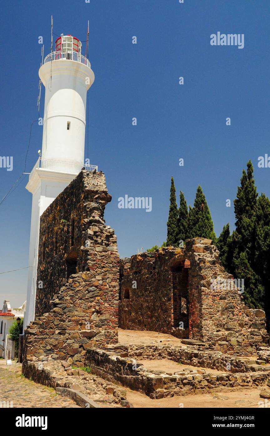 Historic lighthouse over ancient stone ruins in Colonia, Uruguay Stock ...