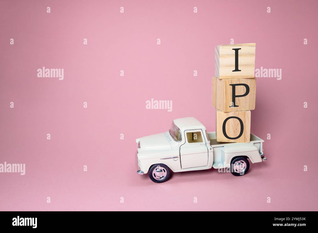 White truck is carrying wooden blocks with the letters IPO on top ...