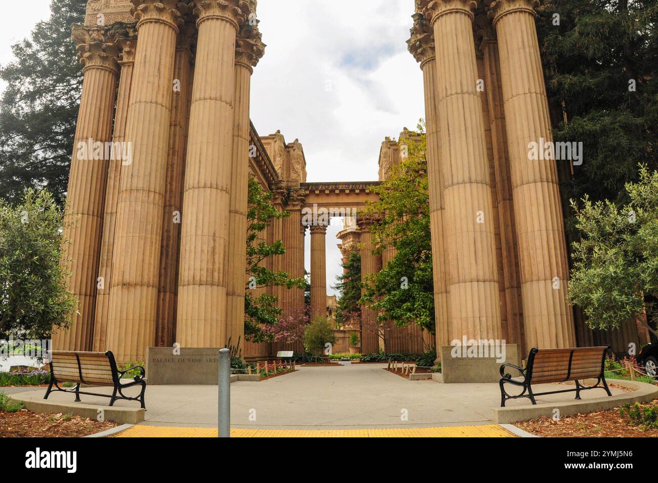 Iconic structure's majestic columns in tranquil park with lush greenery ...