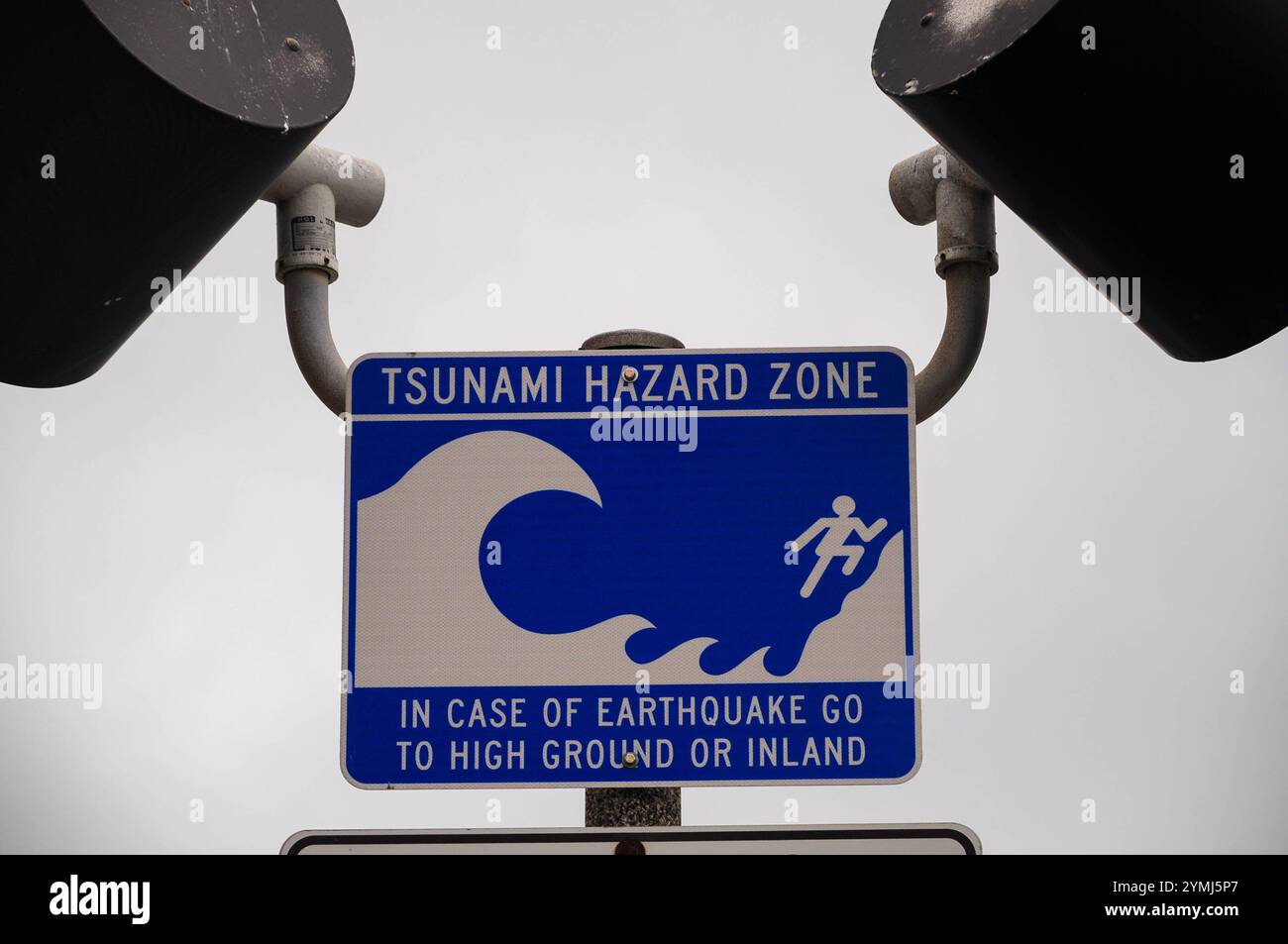 Tsunami hazard sign urging evacuation to higher ground during an ...
