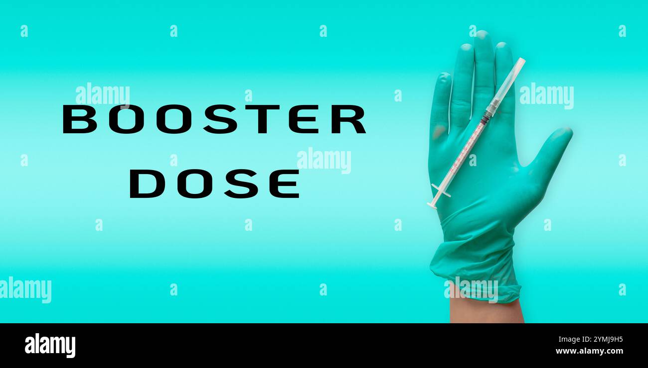 Hand holding a syringe with the words Booster Dose written below it ...