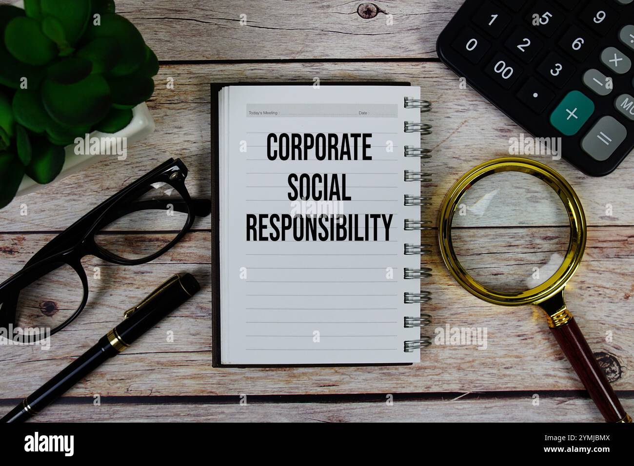 Corporate Social Responsibility (CSR) text on notepad, Business and ...