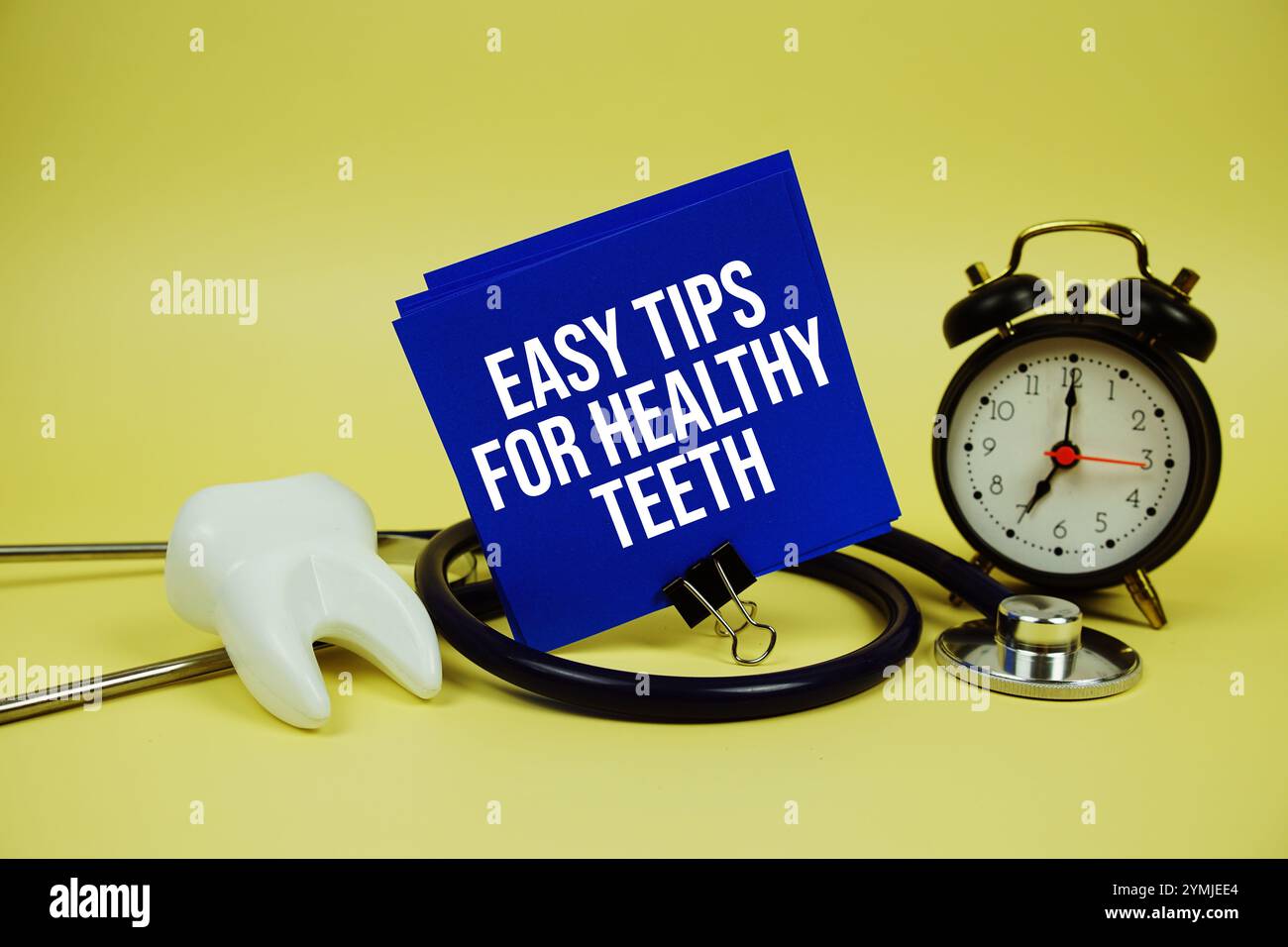 Easy Tips for Healthy Teeth text on paper card with stethoscope, alarm ...