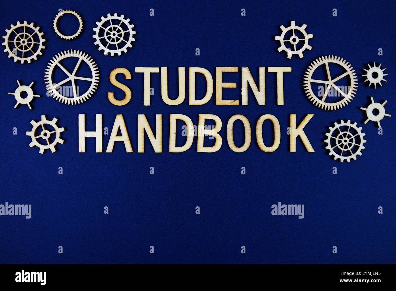 Student Handbook alphabet letters with gears element on navy blue ...