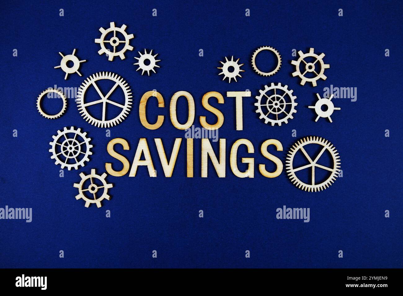 Cost Savings alphabet letters with gears element on navy blue ...